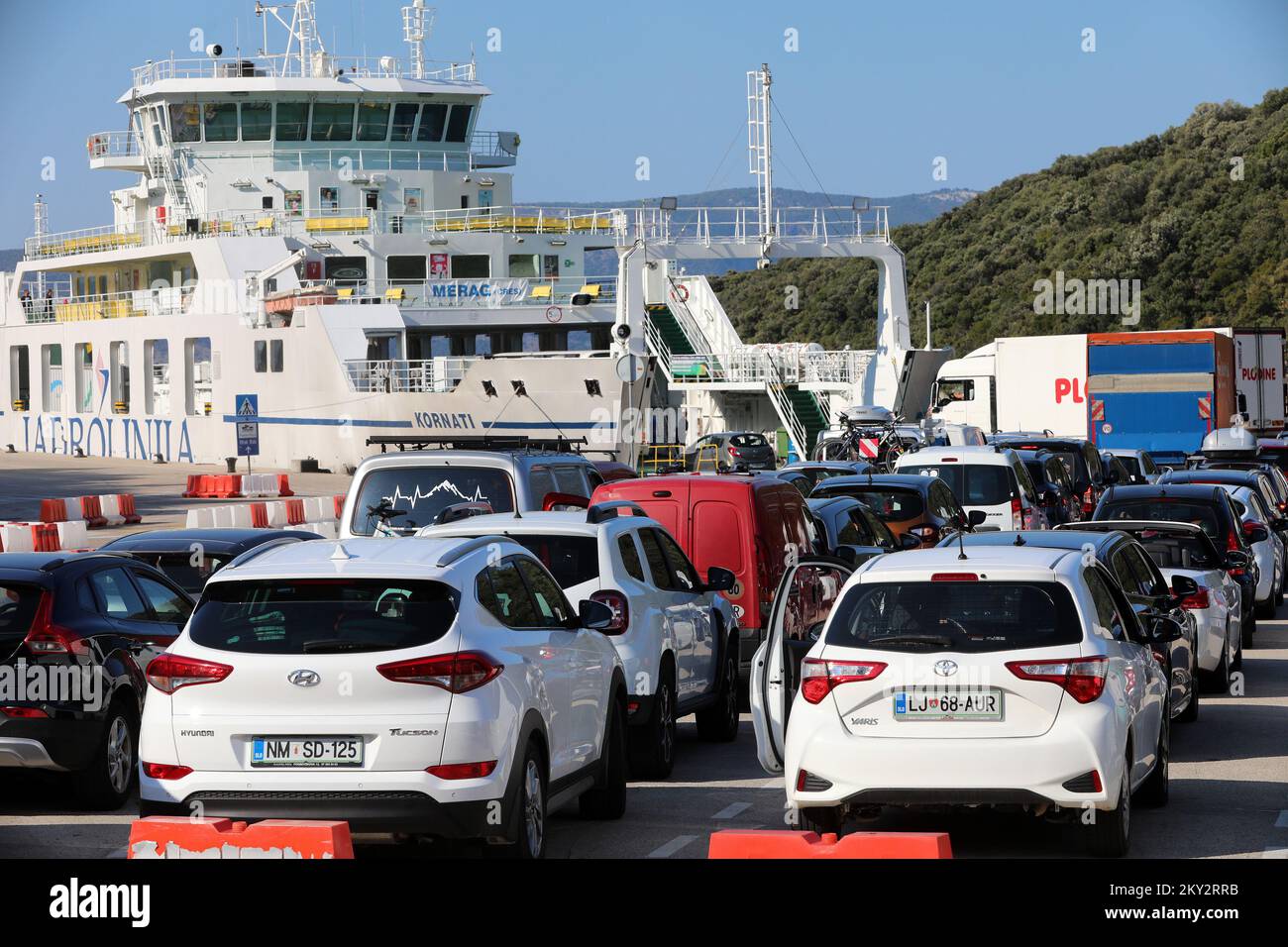 Tourists board the Jadrolinija Kornati and Ilovik ferries at the ...