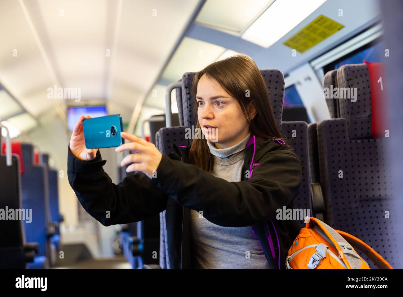Woman photographing view from train window Stock Photo - Alamy