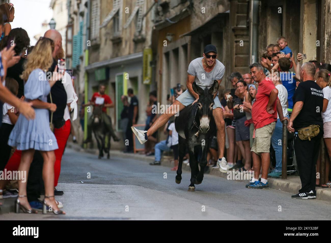 A rider falls from the donkey during the famous Donkey Race of 54 ...