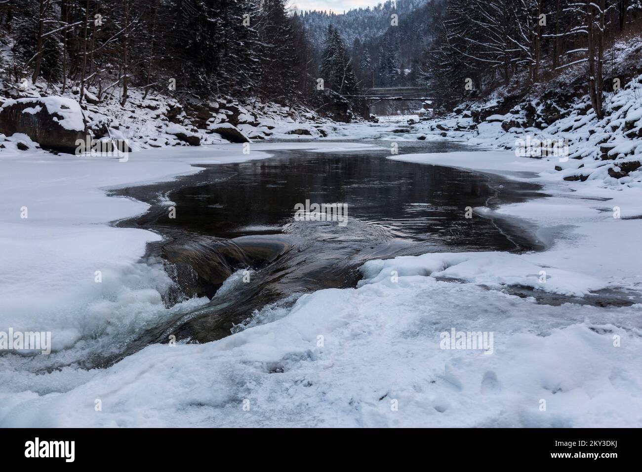 Ice formations on a frozen river covered with snow. Wonderful wintry ...