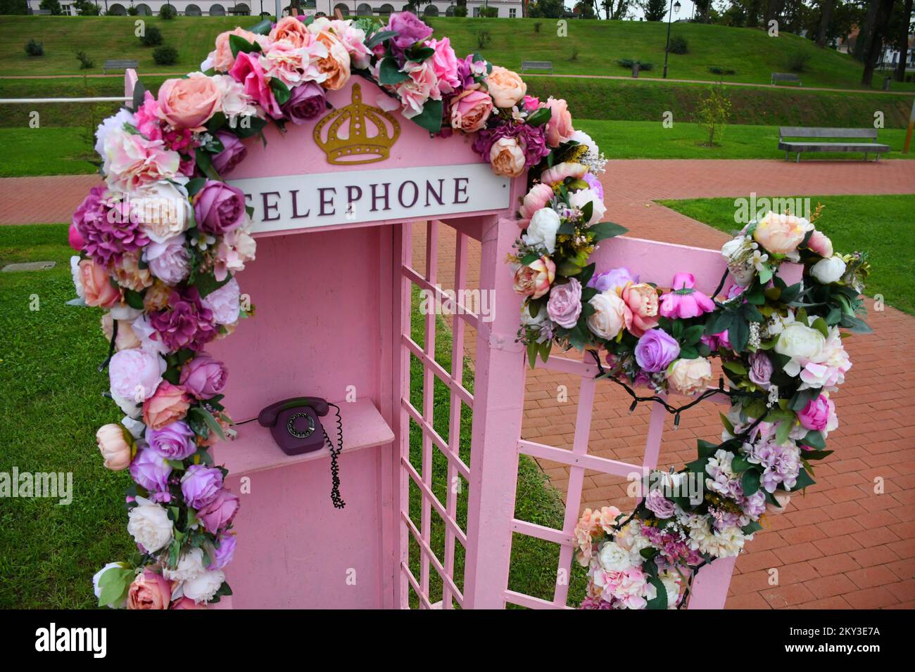 A pink phone booth decorated with flowers adorns the lawn of the newly ...