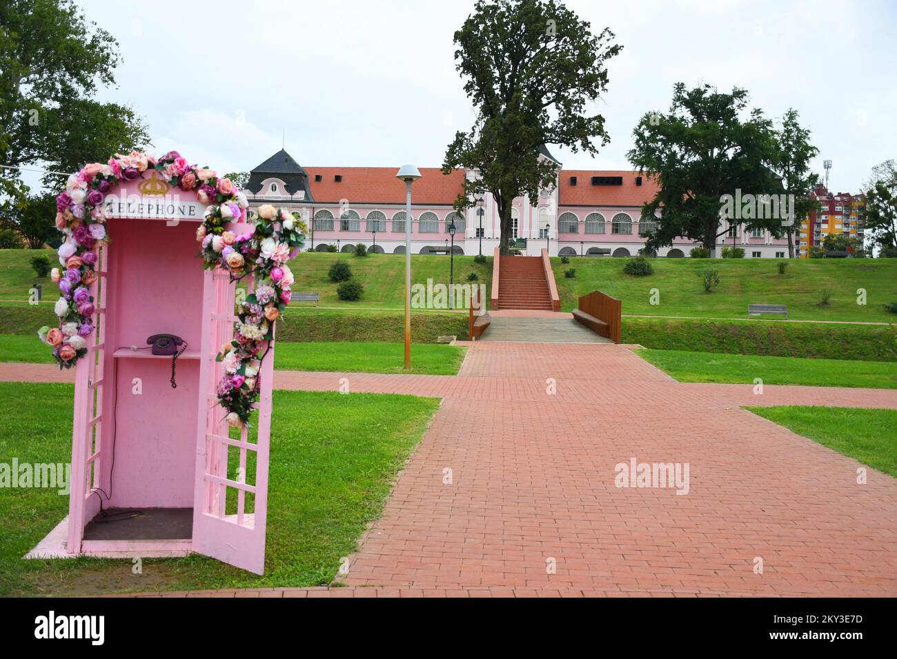 A pink phone booth decorated with flowers adorns the lawn of the newly ...