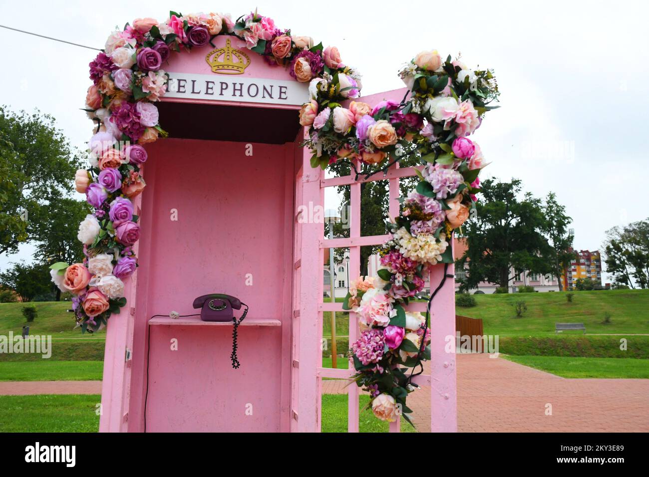 A pink phone booth decorated with flowers adorns the lawn of the newly ...