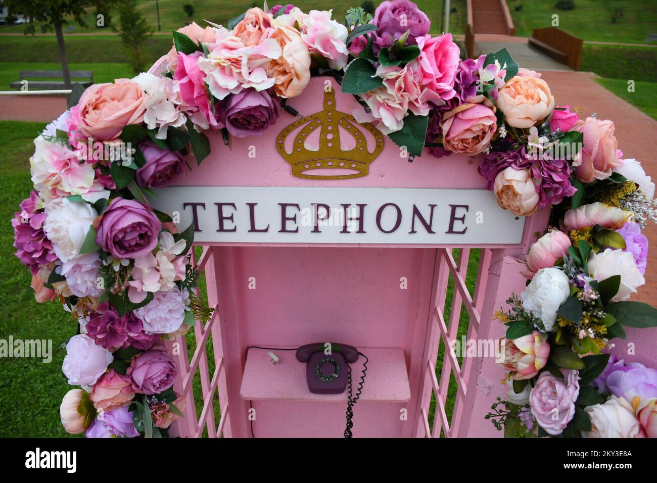 A pink phone booth decorated with flowers adorns the lawn of the newly ...