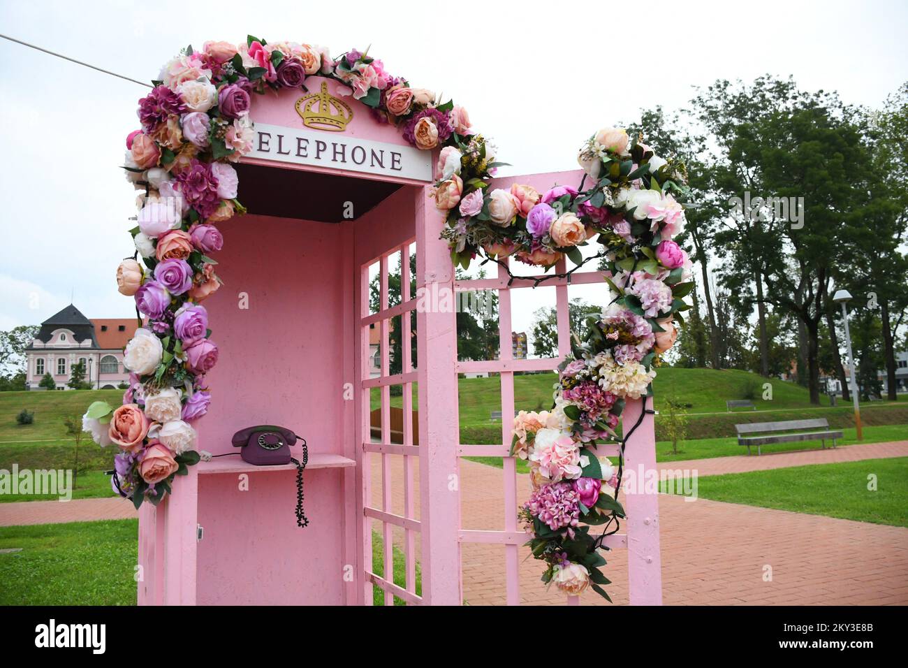 A pink phone booth decorated with flowers adorns the lawn of the newly ...
