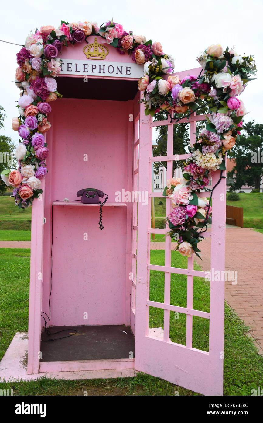 A pink phone booth decorated with flowers adorns the lawn of the newly ...
