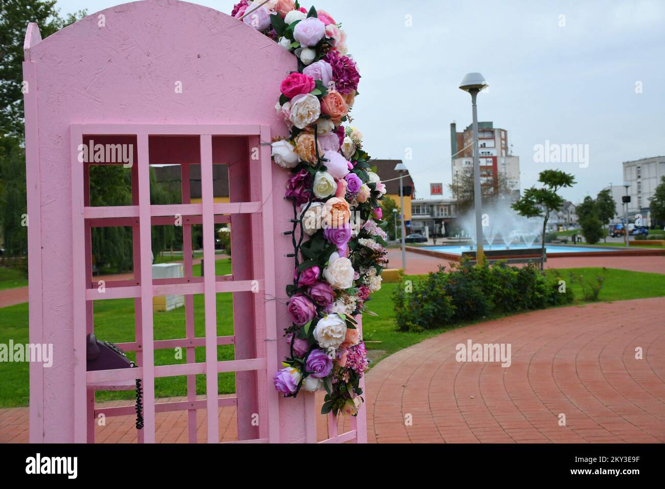 A pink phone booth decorated with flowers adorns the lawn of the newly ...