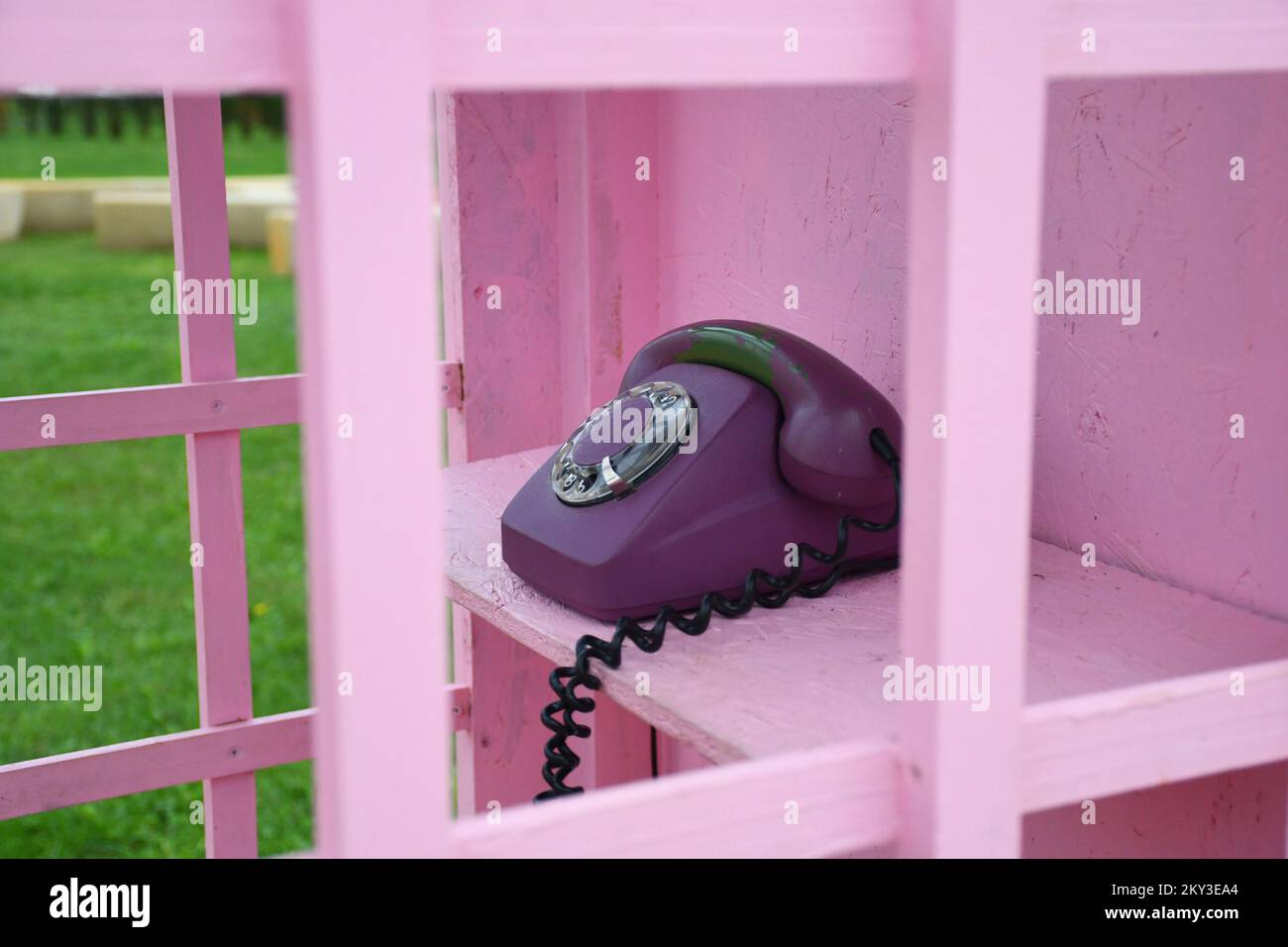 A pink phone booth decorated with flowers adorns the lawn of the newly ...