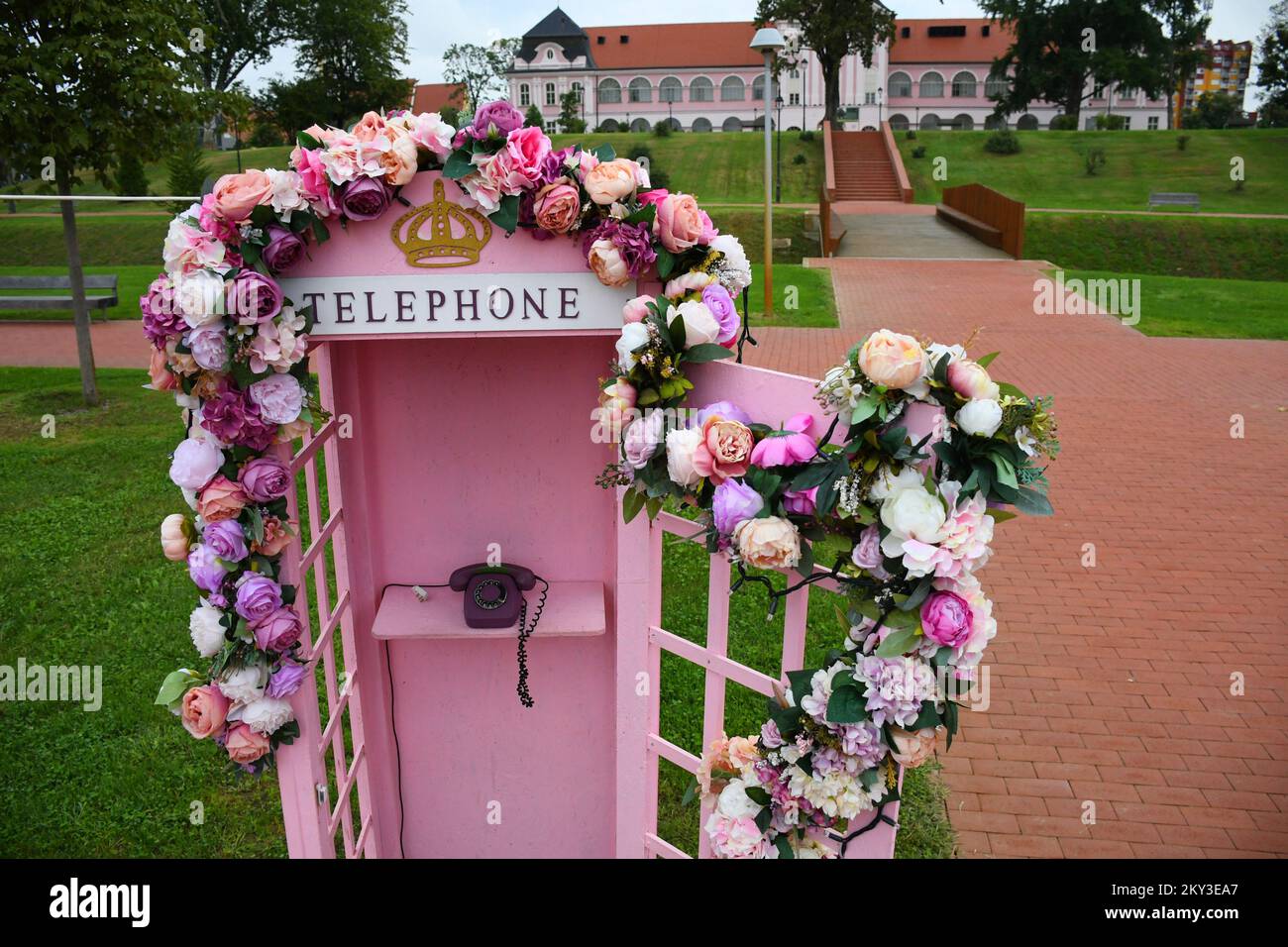 A pink phone booth decorated with flowers adorns the lawn of the newly ...