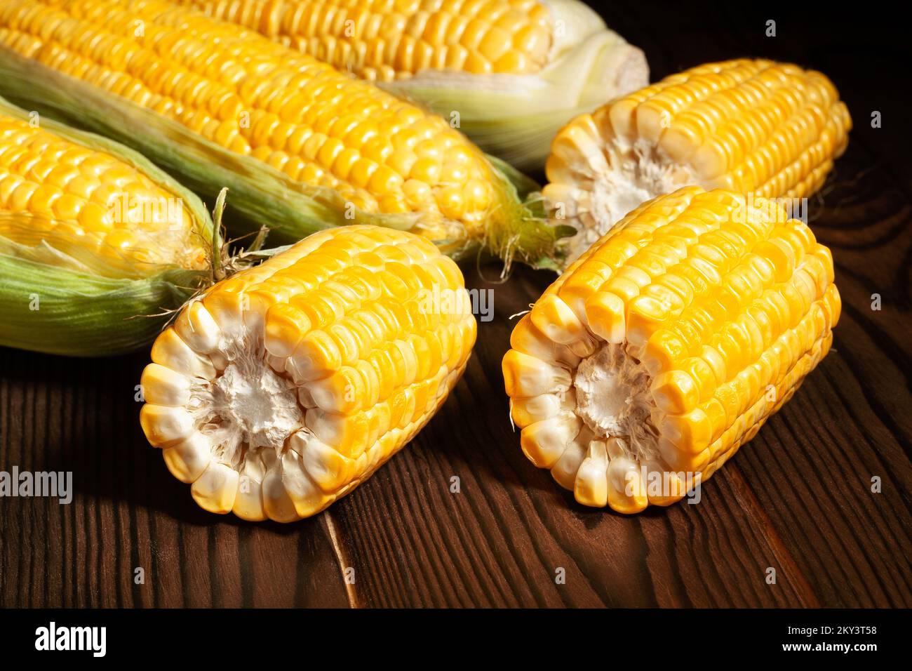 sliced corn on wood background Stock Photo - Alamy