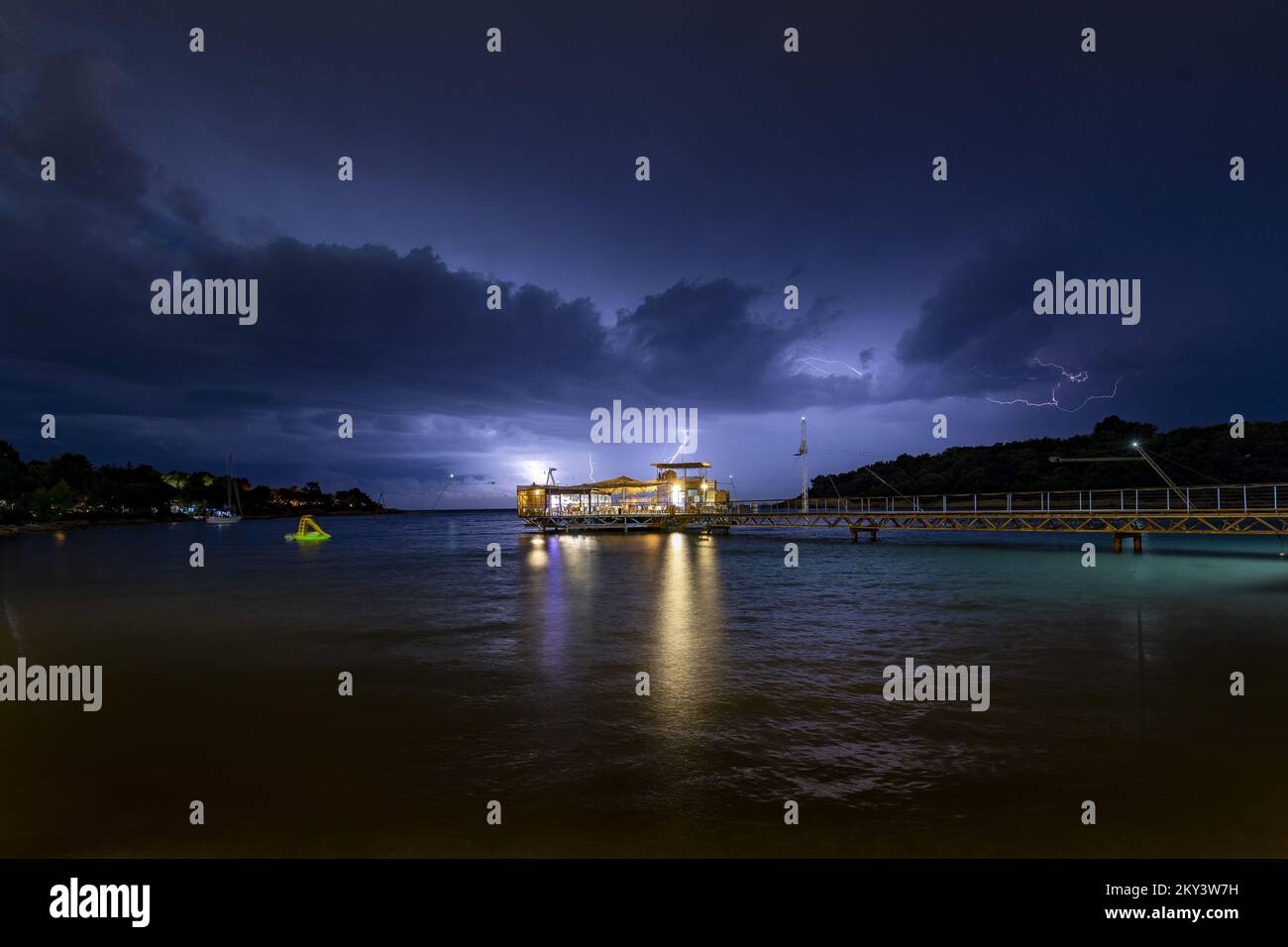 Lightning flashed in the sky above the beach bar in Pula, Croatia on ...
