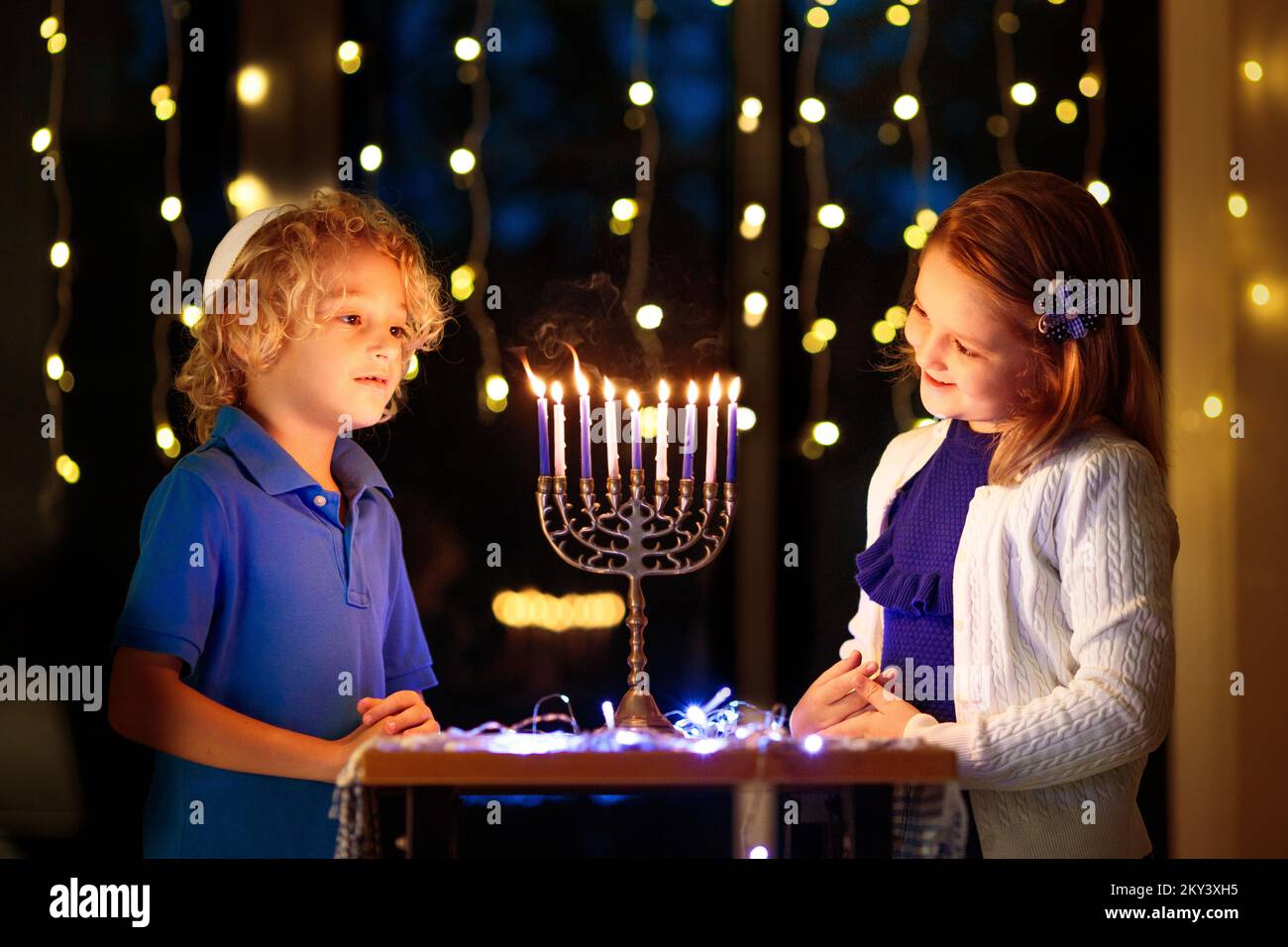 Kids celebrating Hanukkah. Jewish festival of lights. Children lighting ...