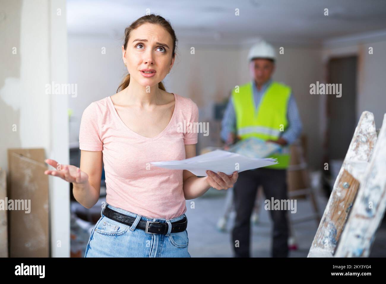 Annoyed woman architect standing at renovating object Stock Photo - Alamy