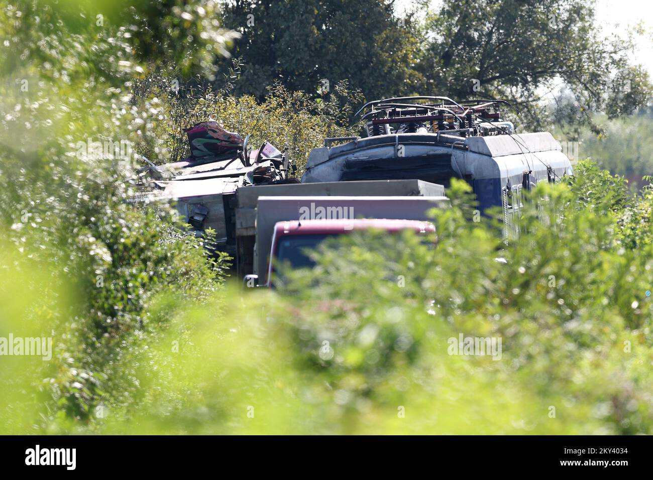Rescue workers work at the crash site where two trains collided in ...