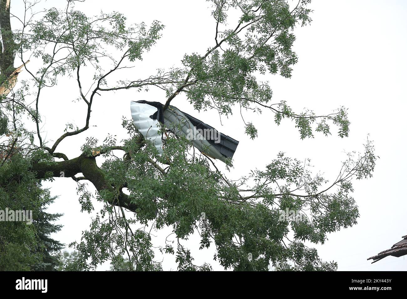 Parts of roofs and roofing tiles scattered around after a heavy storm ...