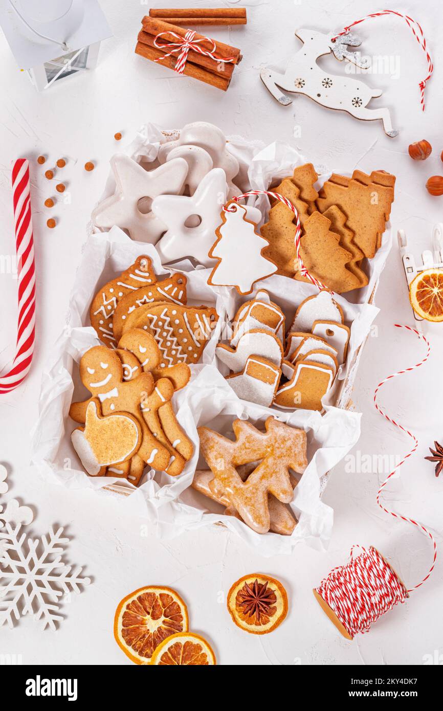 Top view of unpacked christmas present with sweets on a white textured ...
