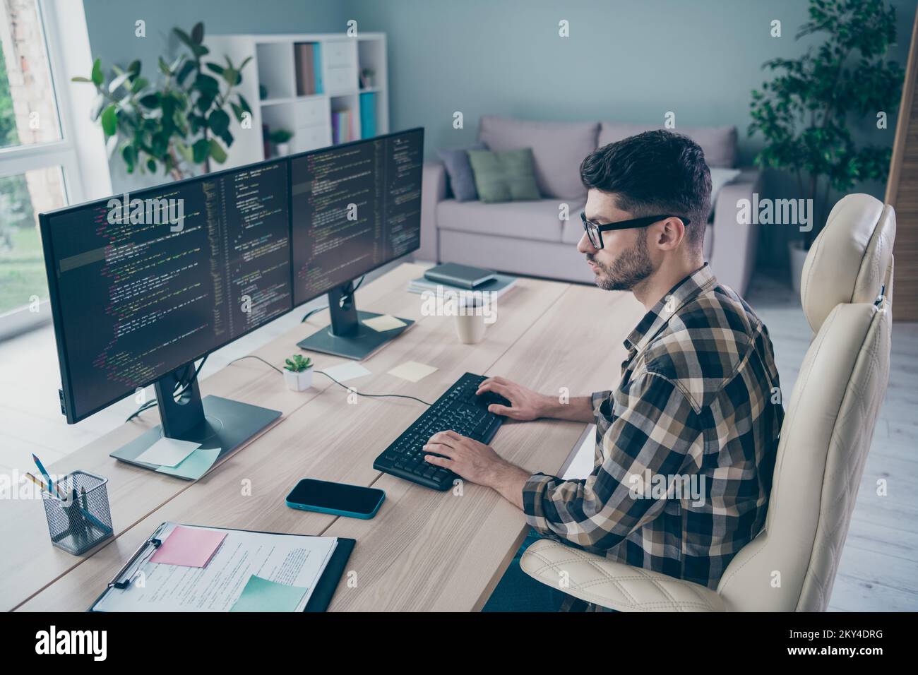 Photo of handsome serious guy wear glasses debugging modern device app ... Photo of handsome serious guy wear glasses debugging modern device app ...