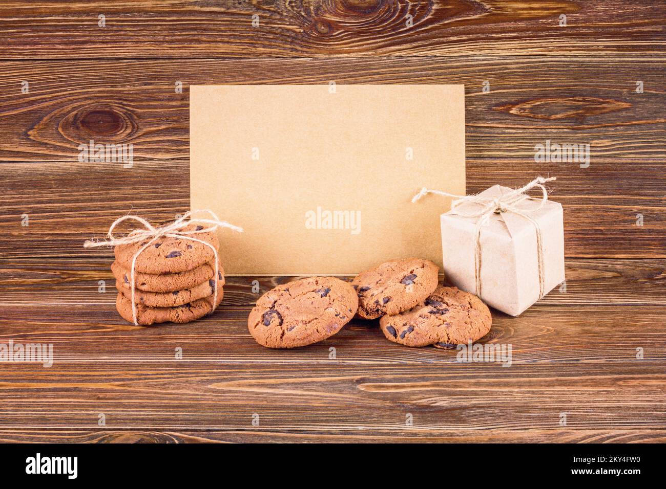 View of oatmeal cookies and gift on wooden table with space for ...