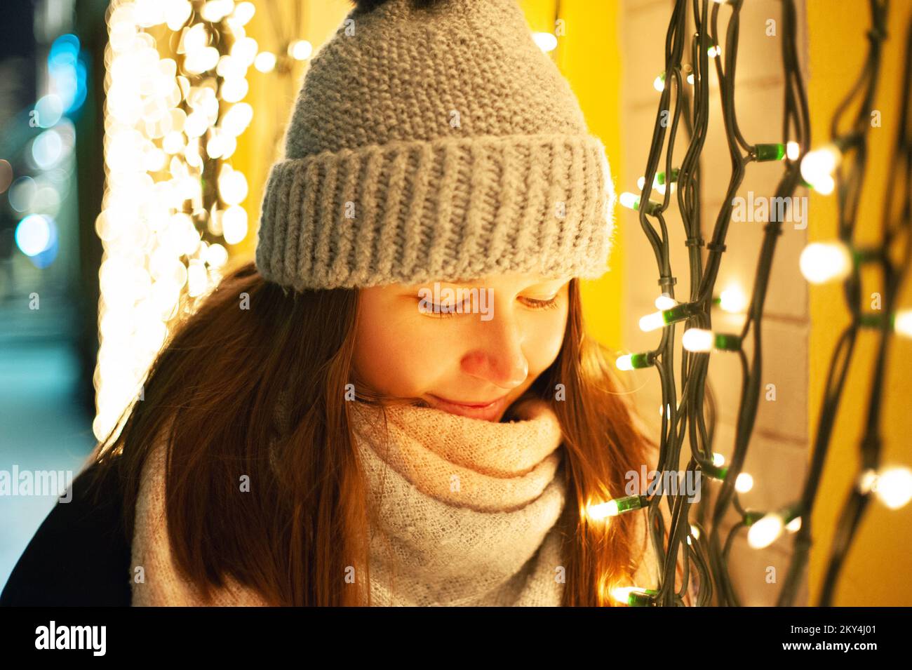 Smiling a pretty young woman with a winter hat on the New Year's ...