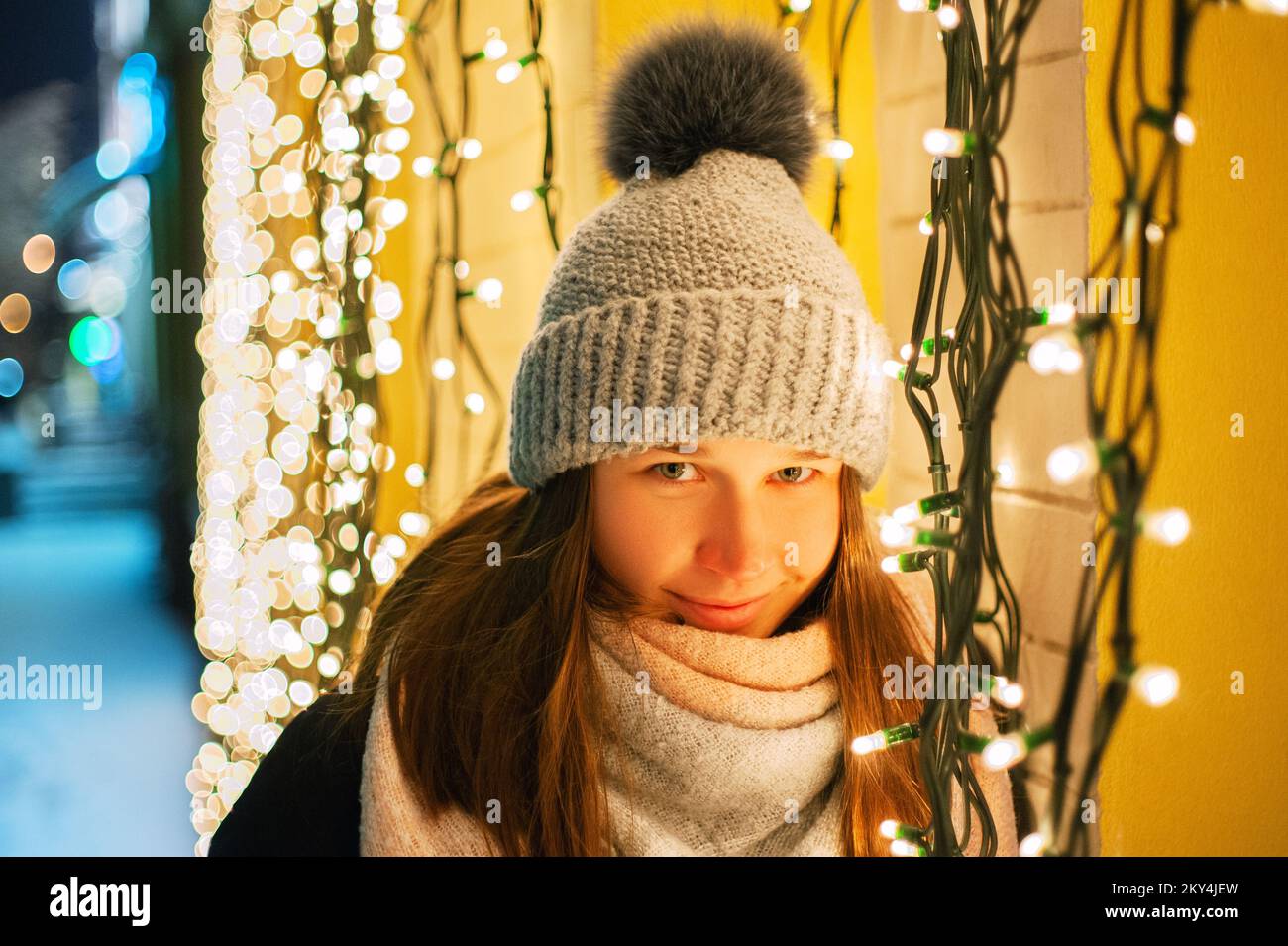 Smiling a pretty young woman with a winter hat on the New Year's ...