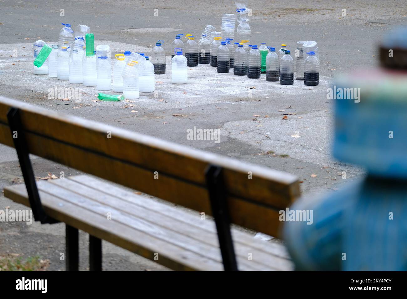Big chess board of chalk with chess pieces made of plastic bottles seen ...