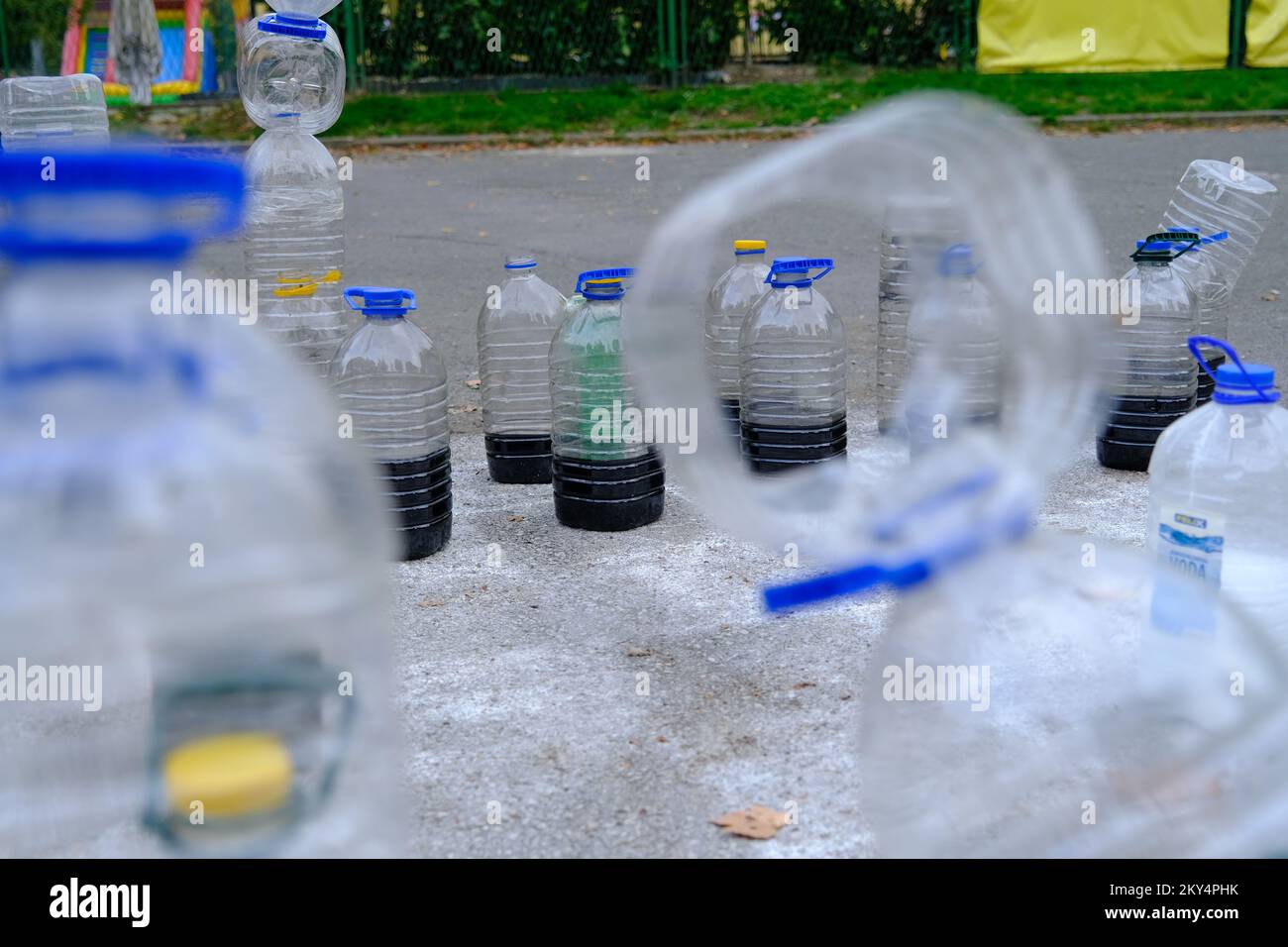 Big chess board of chalk with chess pieces made of plastic bottles seen ...
