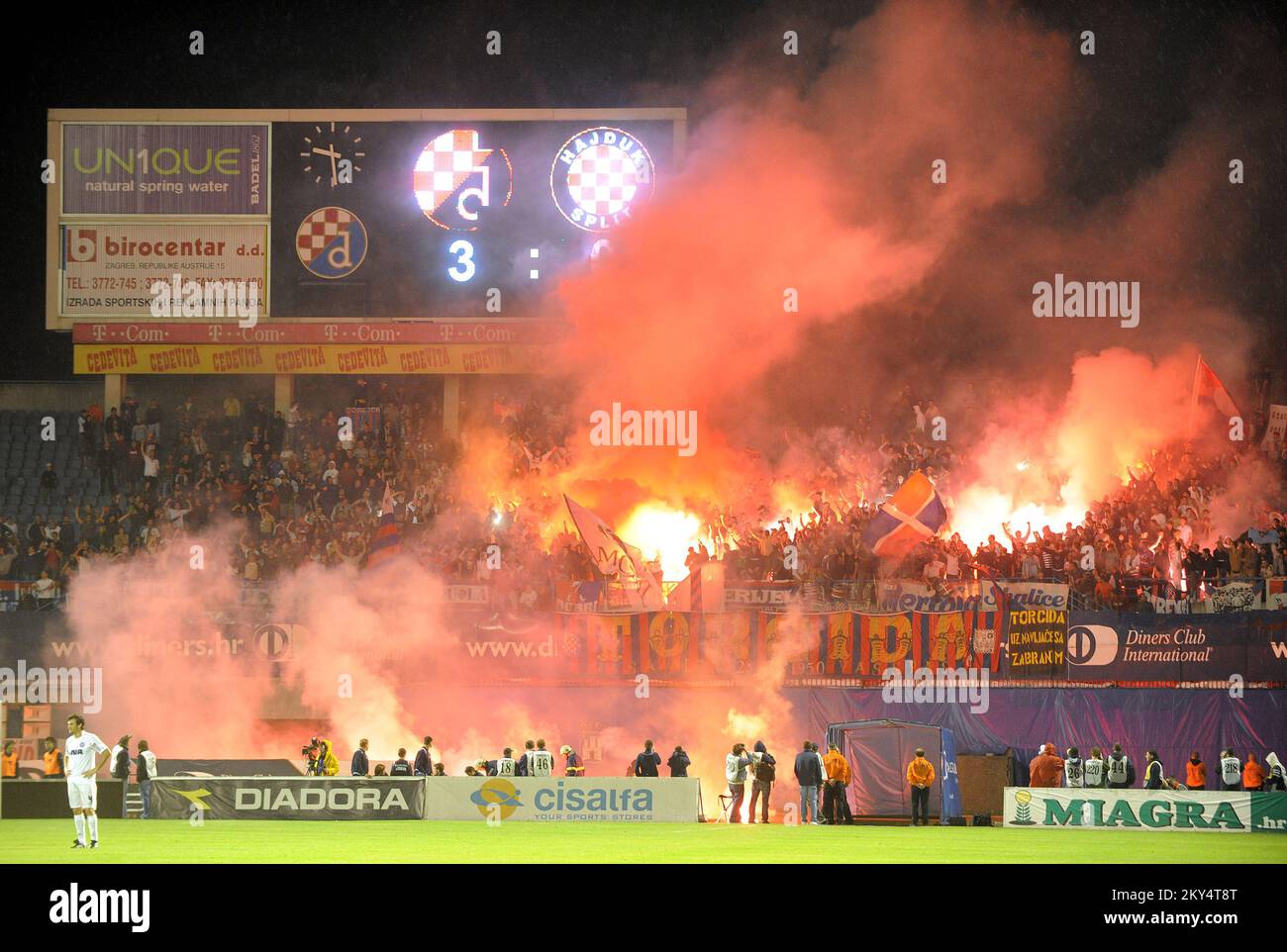 Fans light flare's in the stands Stock Photo - Alamy