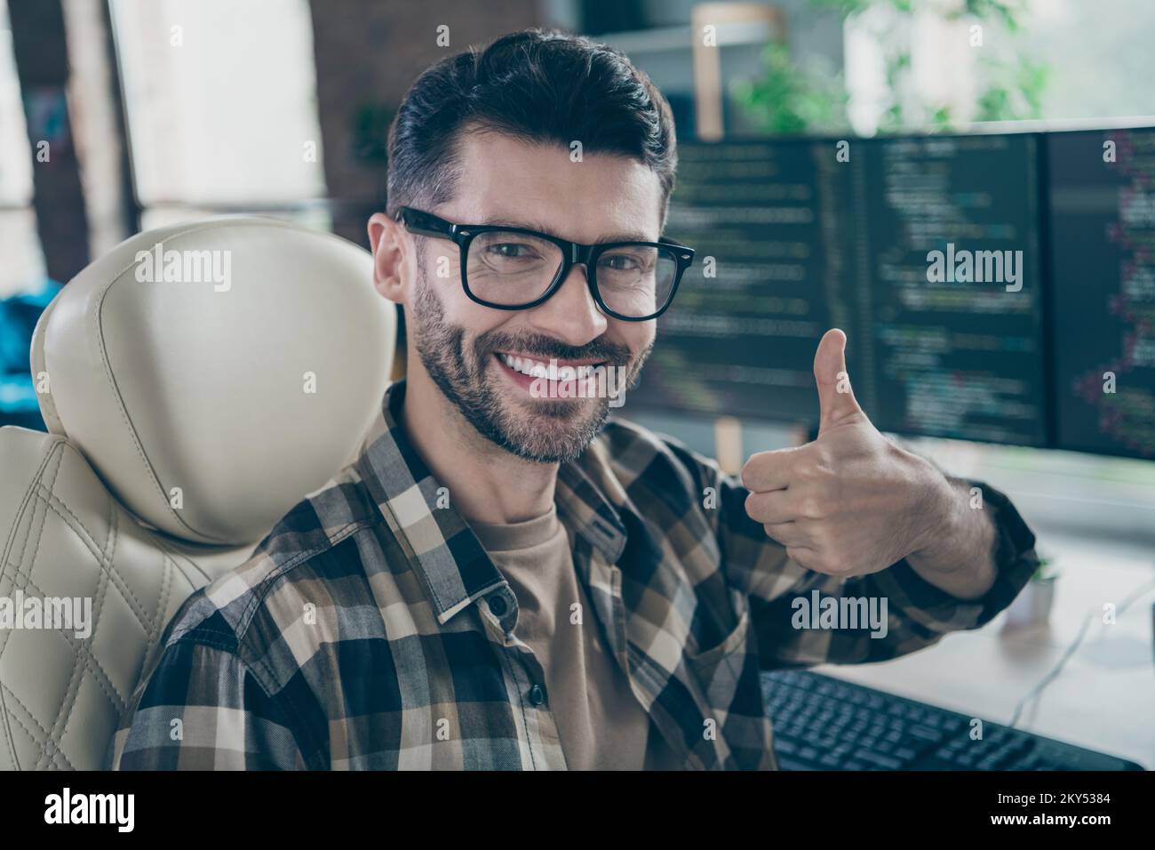 Portrait of positive web designer man sitting chair toothy smile hand ...