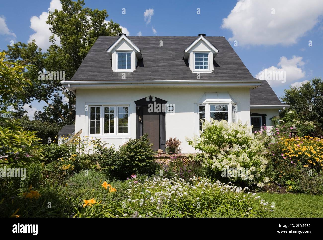 Two storied white with black trim French manor Canadiana style home ...