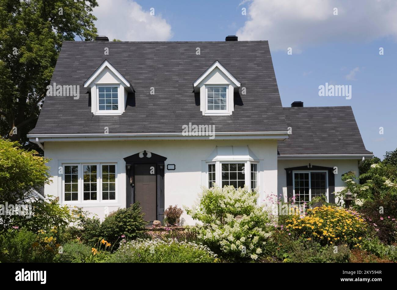 Two storied white with black trim French manor Canadiana style home ...