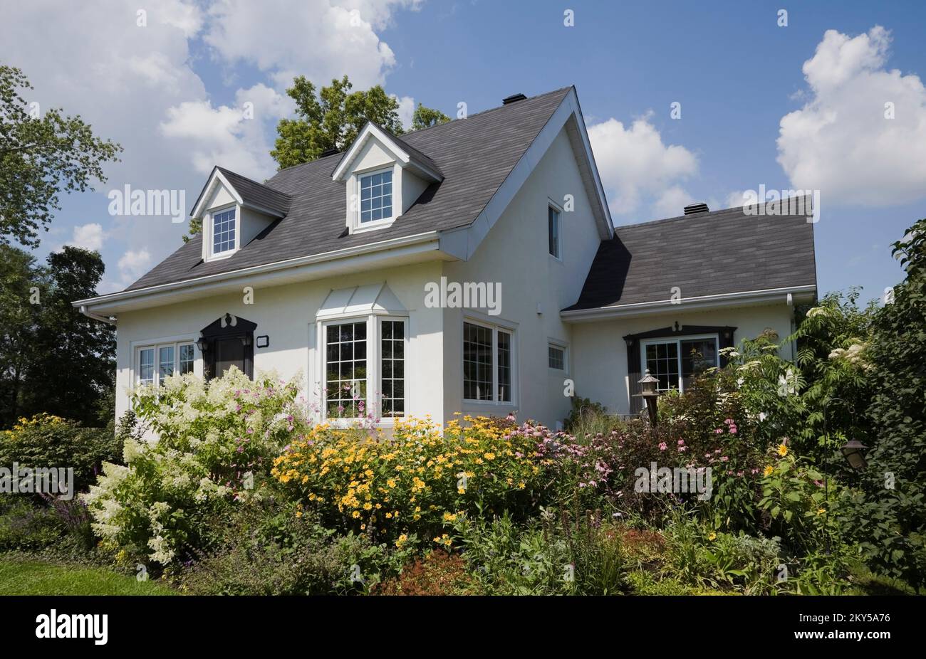 Two storied white with black trim French manor Canadiana style home ...