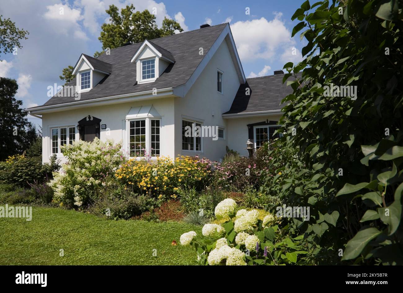 Two storied white with black trim French manor Canadiana style home ...