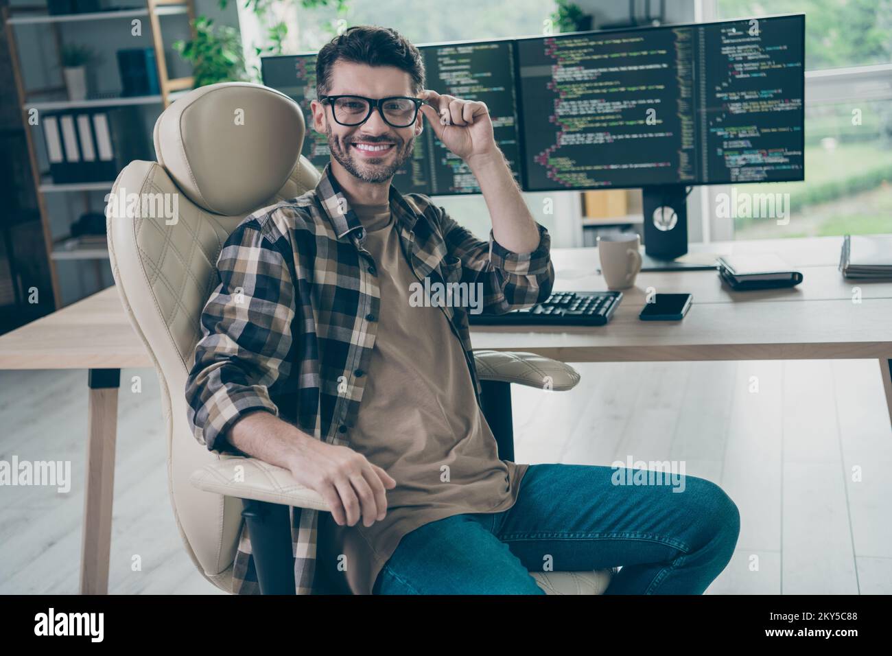 Portrait of intelligent pc operator sitting chair hand touch eyewear ...