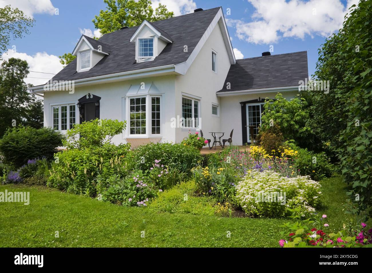 Two storied white with black trim French manor Canadiana style home ...