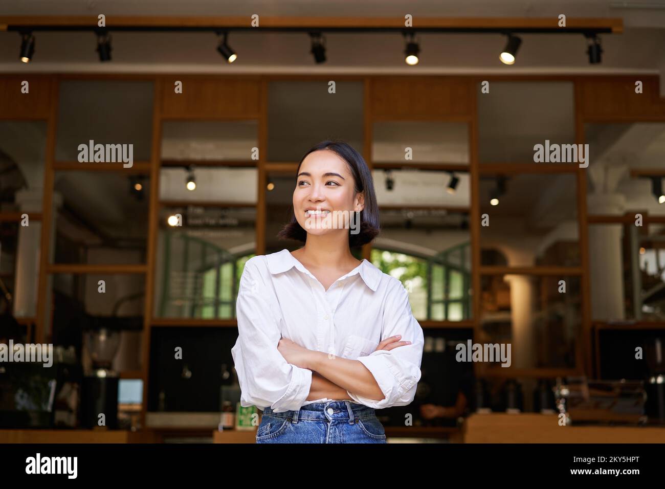 Portrait of confident young asian woman, business owner, cross arms on ...