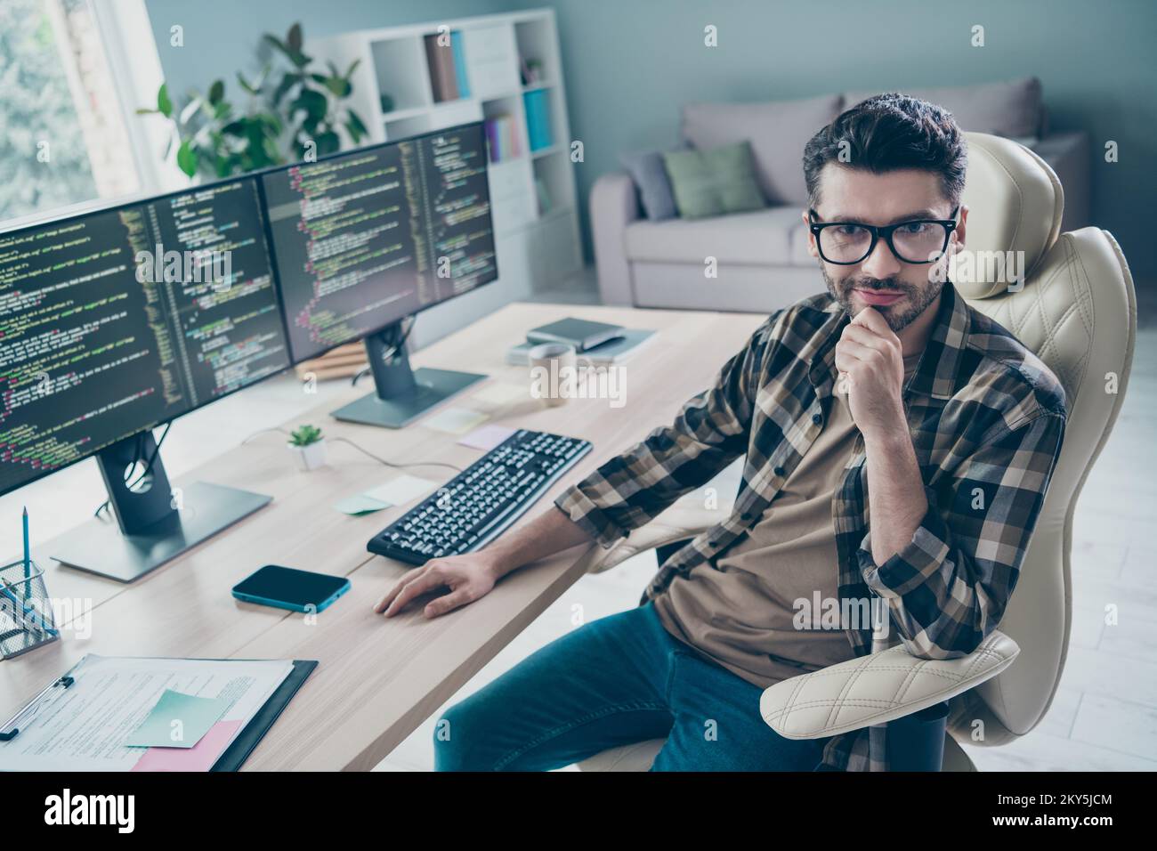 Photo of busy smart programmer wear spectacles arm hand chin testing ...