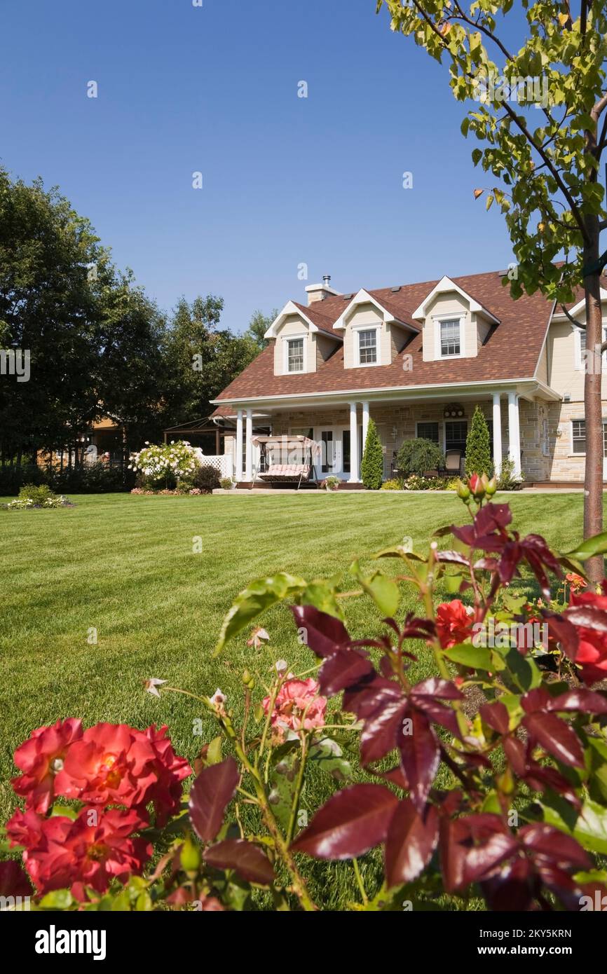 Landscaped backyard with modern style two storied Canadiana home in ...