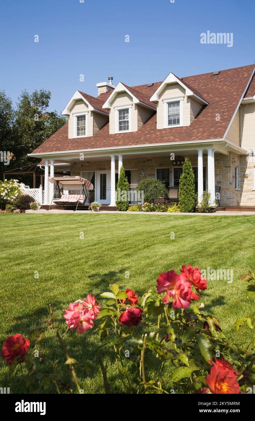 Landscaped backyard with modern style two storied Canadiana home in ...
