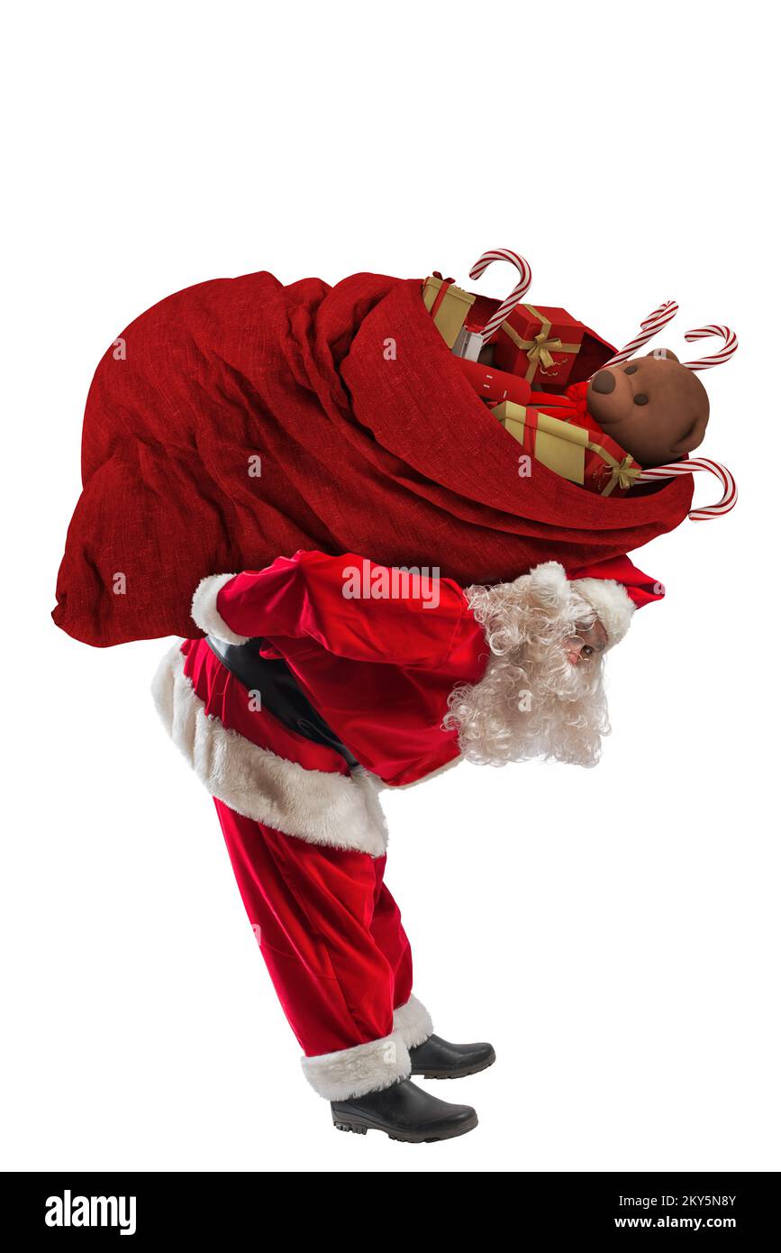 Santa claus carry a big sack full o christmas gifts Stock Photo - Alamy
