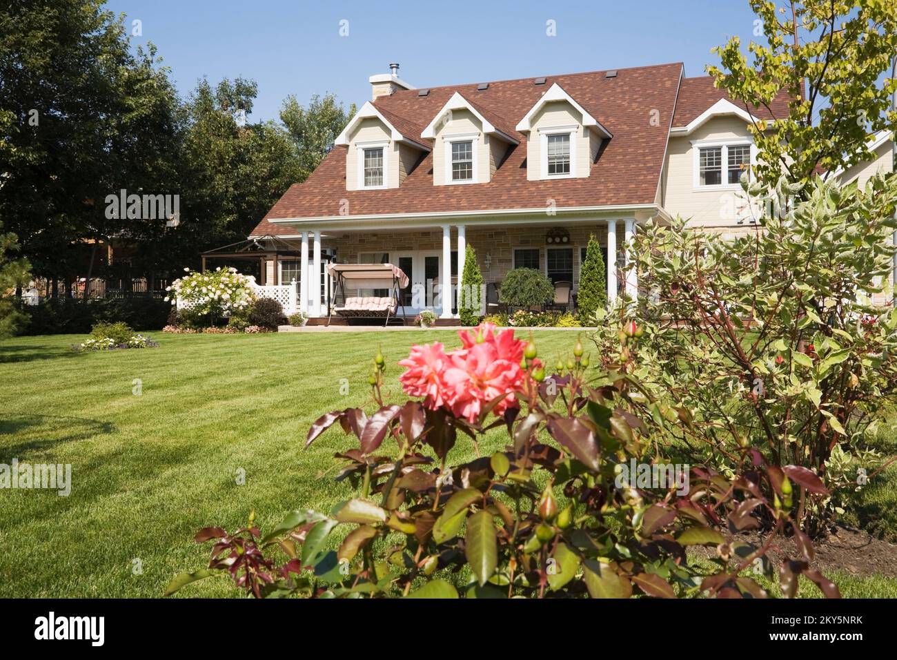 Landscaped backyard with modern style two storied Canadiana home in ...