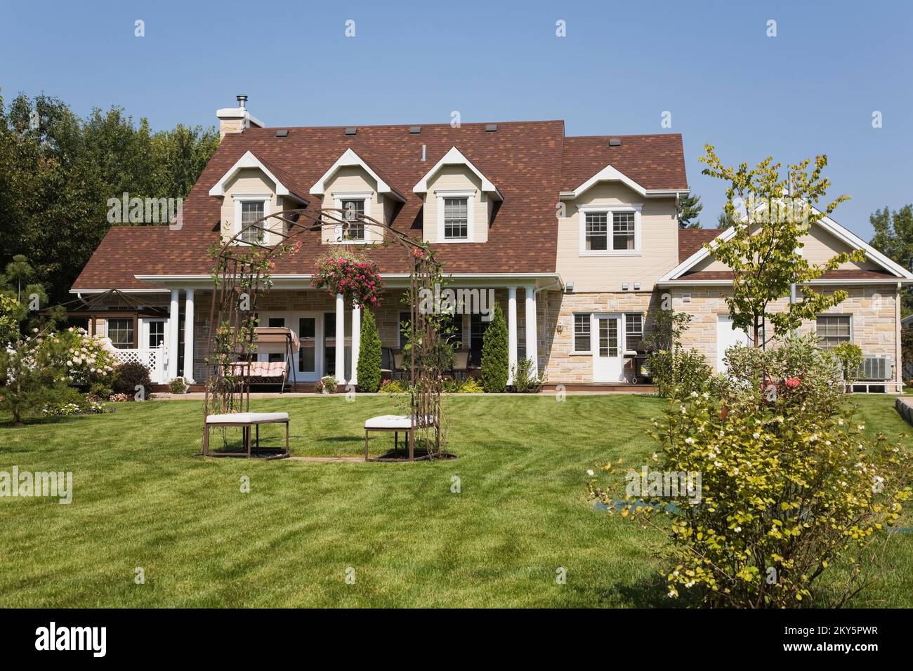 Landscaped backyard with modern style two storied Canadiana home in ...