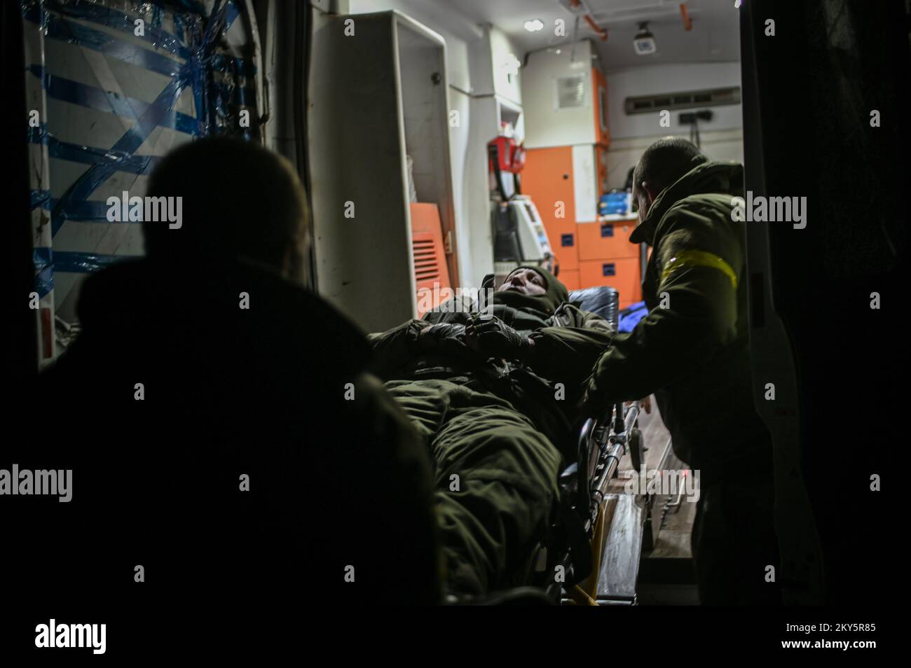 A Ukrainian servicemember wounded by small arms fire is unloaded from ...