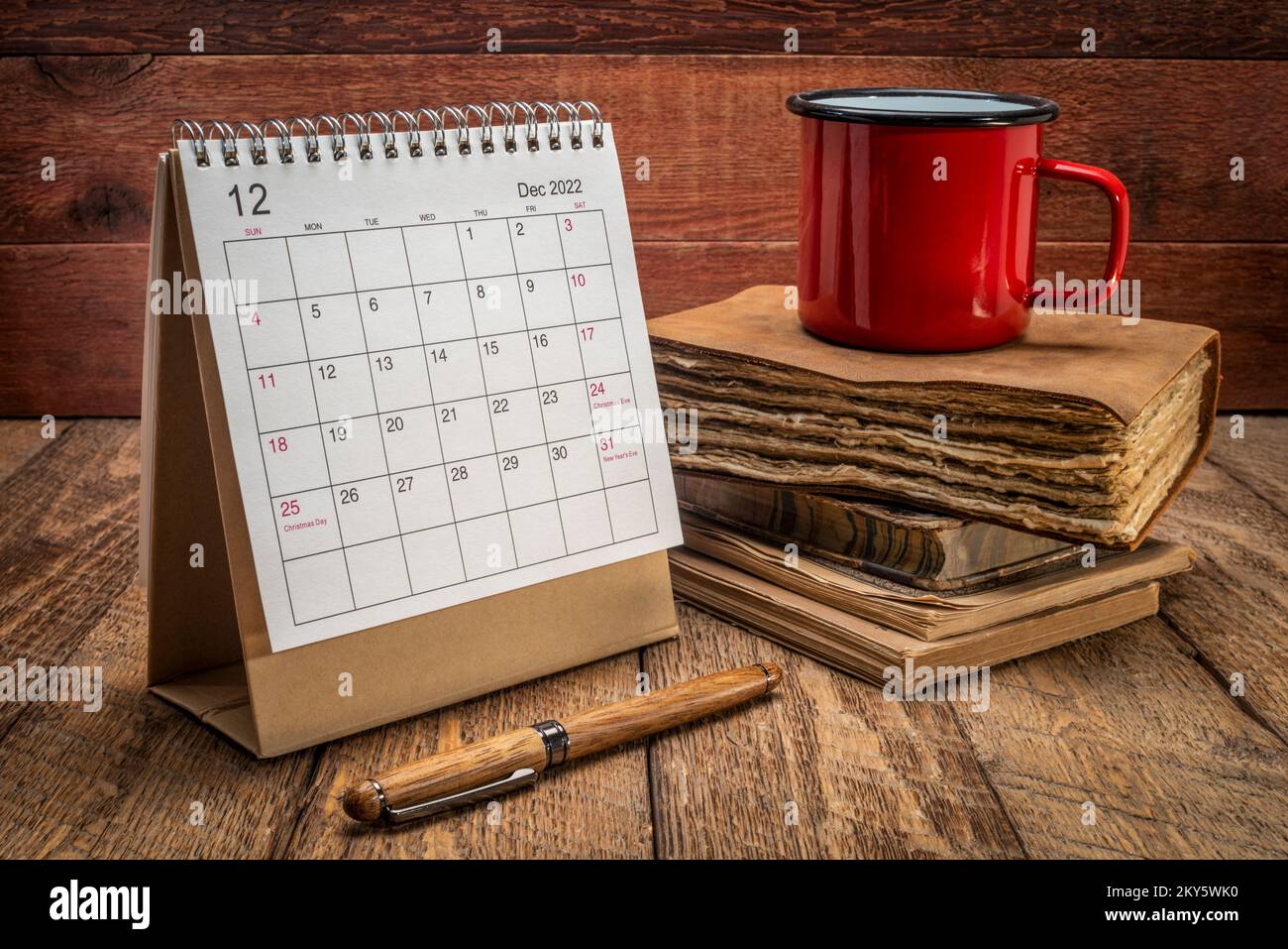 December 2022 - spiral desktop calendar with a stylish pen and vintage ...