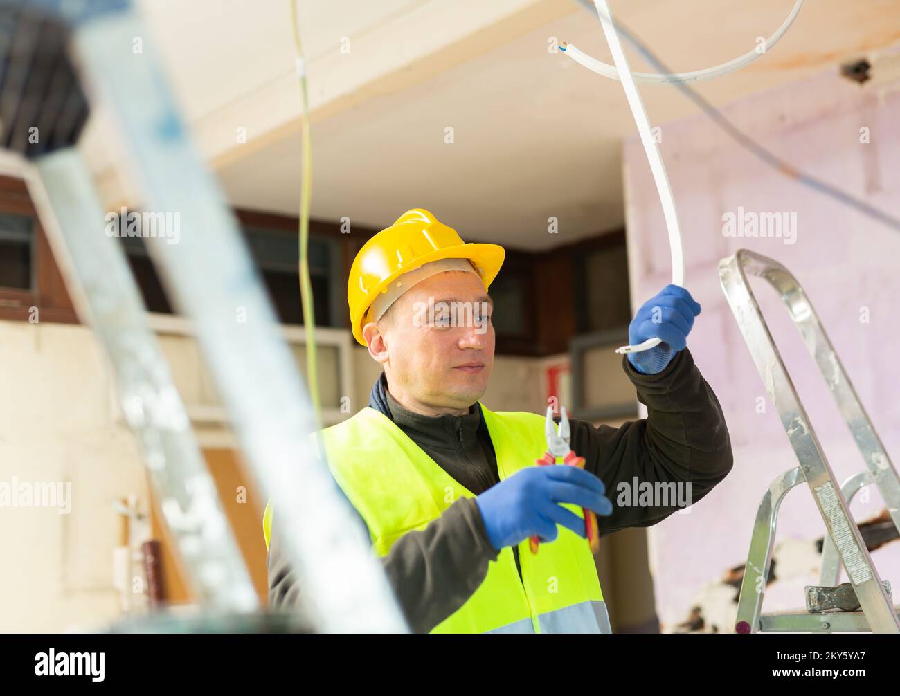 Repair man working on electric wires Stock Photo - Alamy