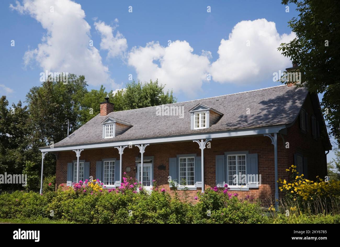 Old 1858 red nuanced brick home with gray, white trim. long veranda and ...