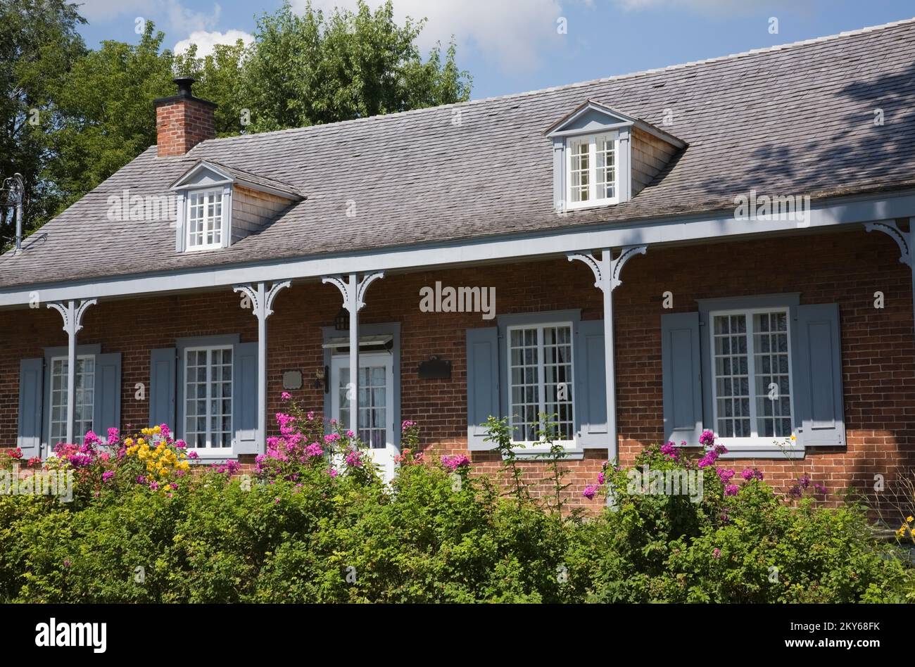 Old 1858 red nuanced brick home with gray, white trim. long veranda and ...