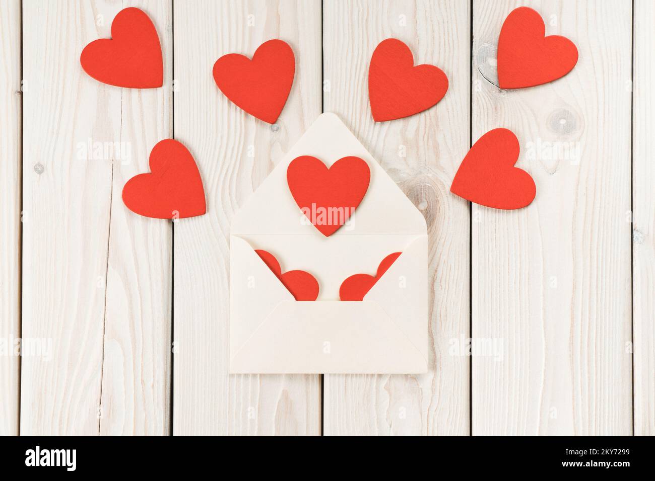 White paper craft envelope opening and giving composition of red paper ...