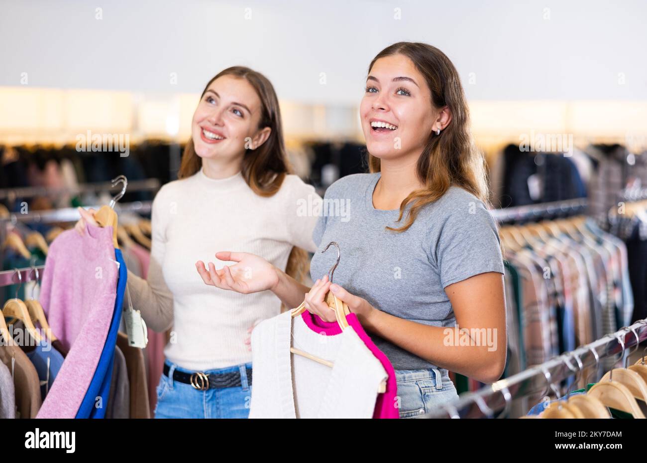 Two women shopping warm clothes in store Stock Photo - Alamy