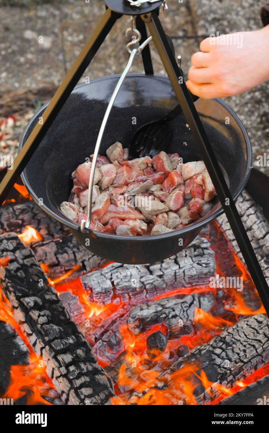 Meat in a cauldron.food on the fire.Cooking outdoors and on the go ...