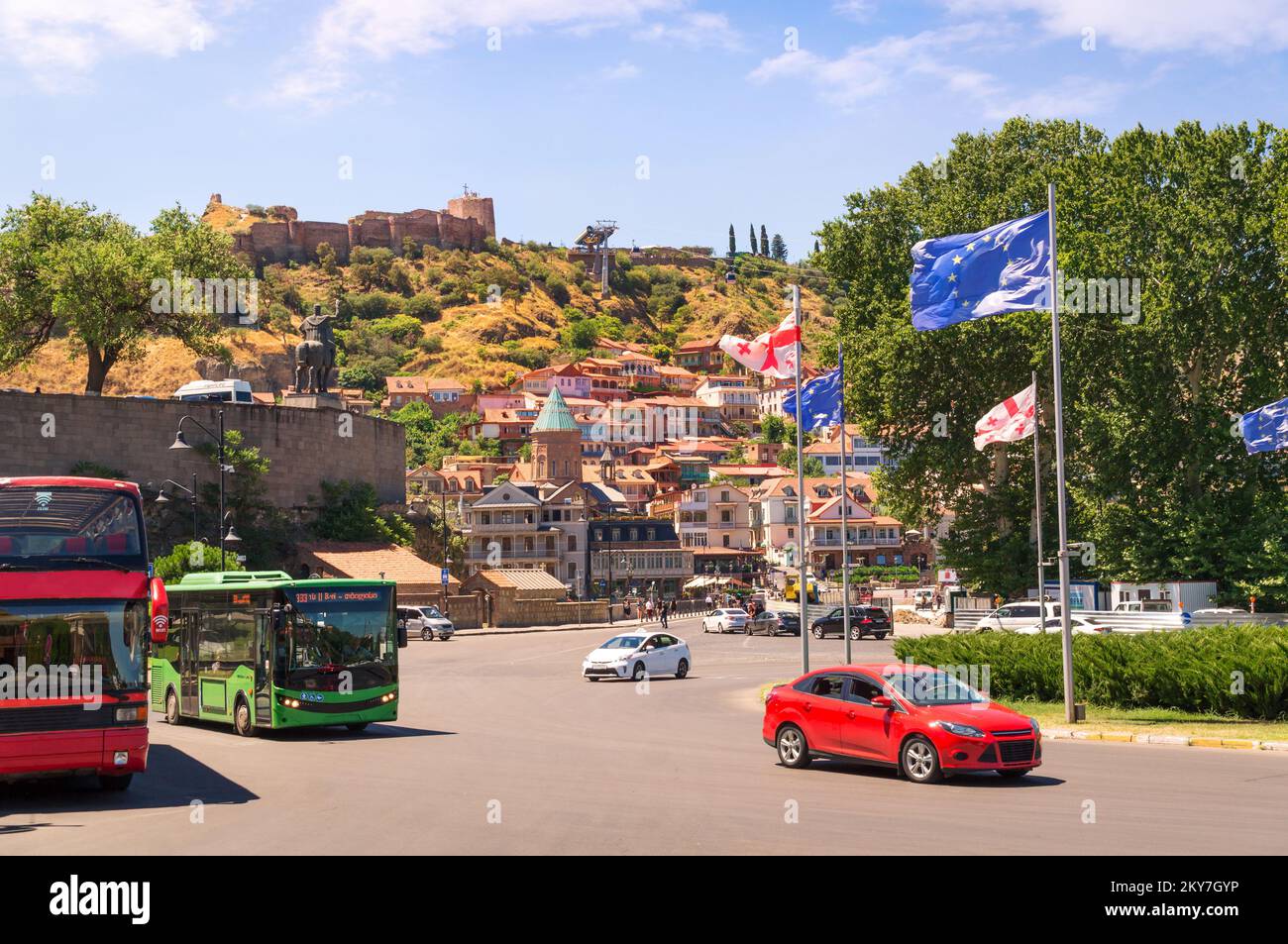 Traffic on a roundabout on Noe Jordania street in foreground and dome ...